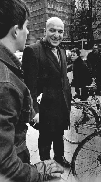 Actor Telly Savalas surrounded by young fans with bikes